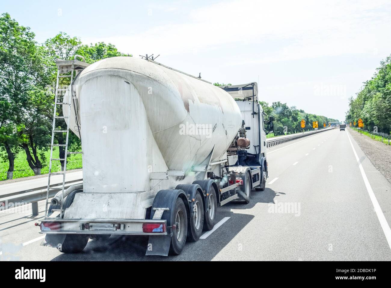 Cement locomotive rides on the track, white cement truck carries cement ...