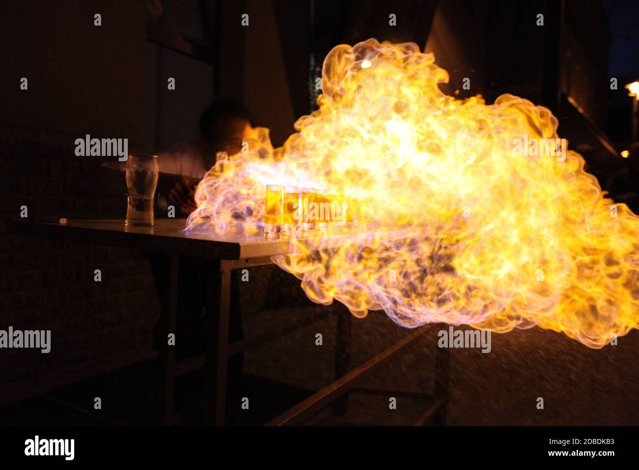 Bartender throwing flame on alcoholic drinks Stock Photo - Alamy