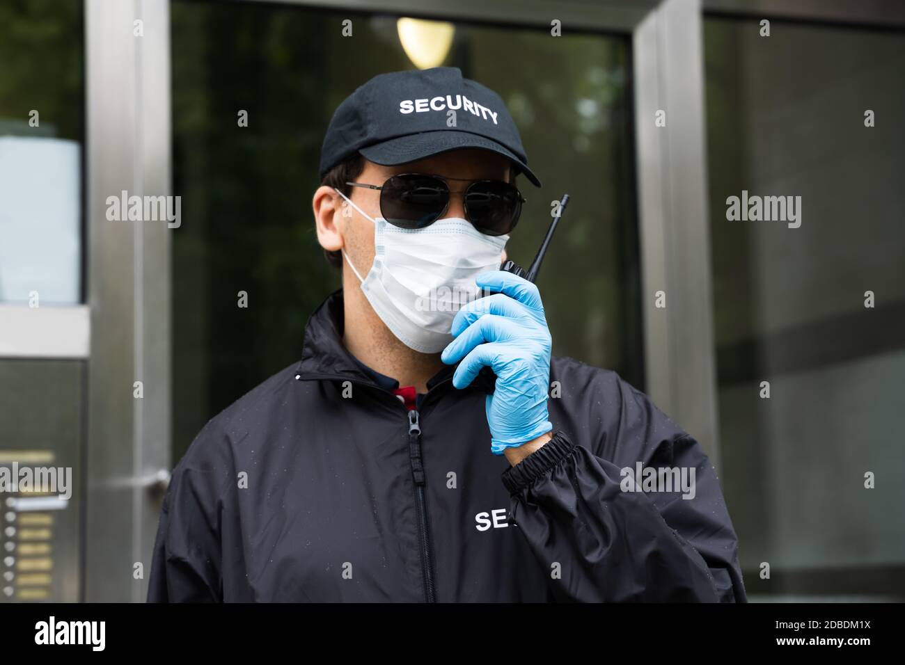 Security guard talking on walkie talkie hi-res stock photography and ...