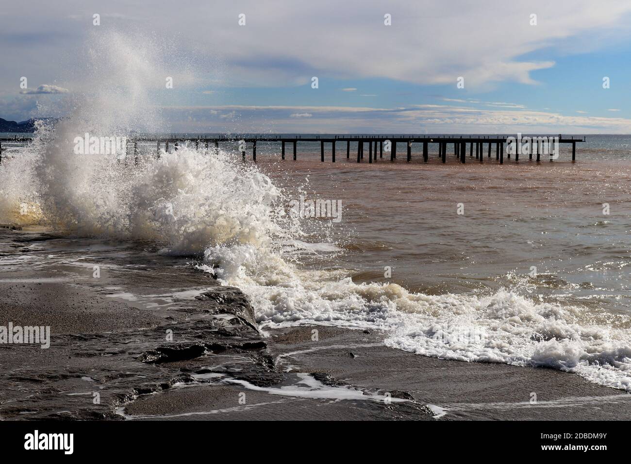 Pier seascape with splashing wave on foreground Stock Photo - Alamy