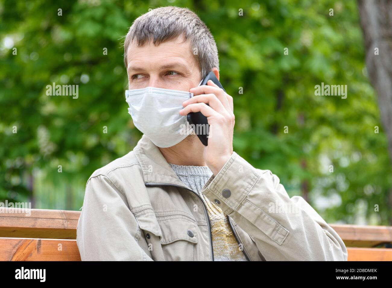 Masked man mobile phone hi-res stock photography and images - Alamy