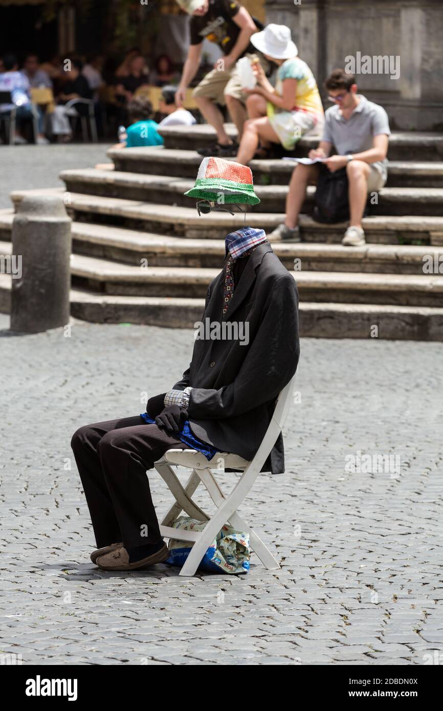 Street performer is showing a magical trick, body without a head in ...
