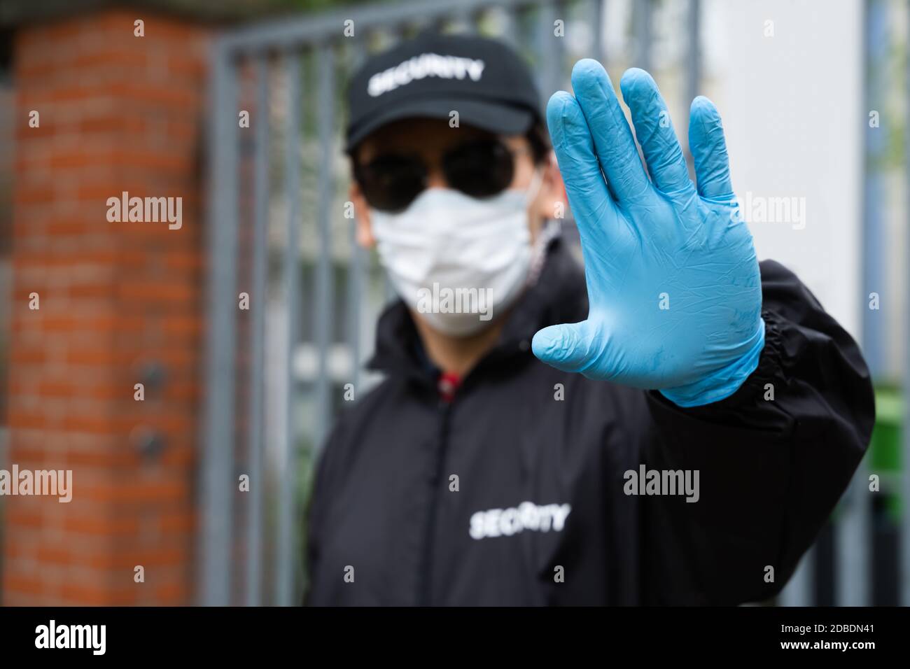 Security Guard In Uniform And Face Mask Making Stop Hand Gesture Stock ...