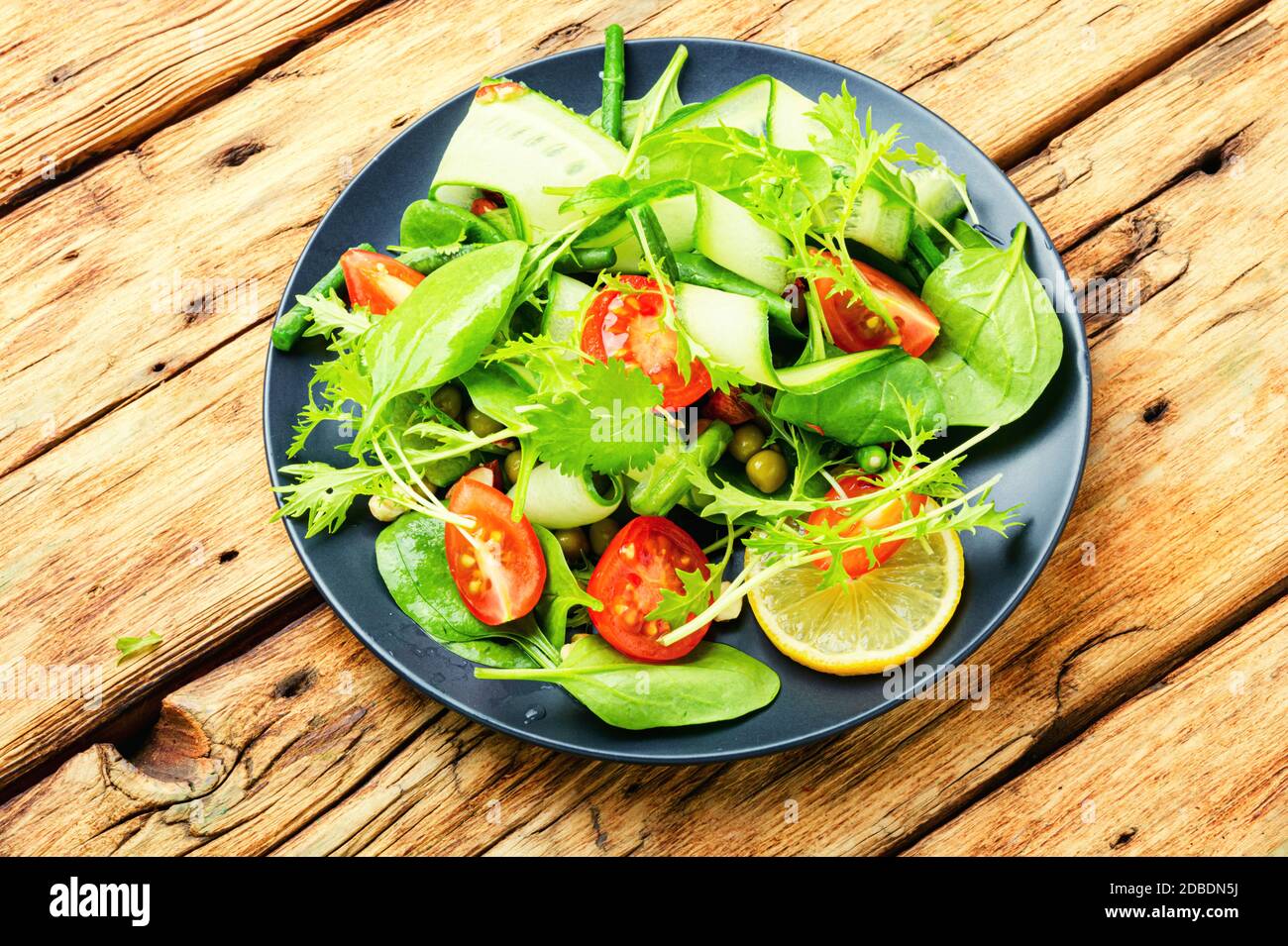 Spring green salad with vegetables and nuts.Diet menu Stock Photo - Alamy