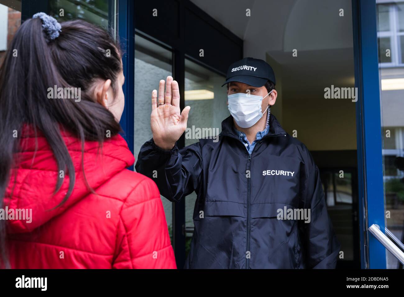 Security Guard In Uniform And Face Mask Making Stop Hand Gesture Stock ...