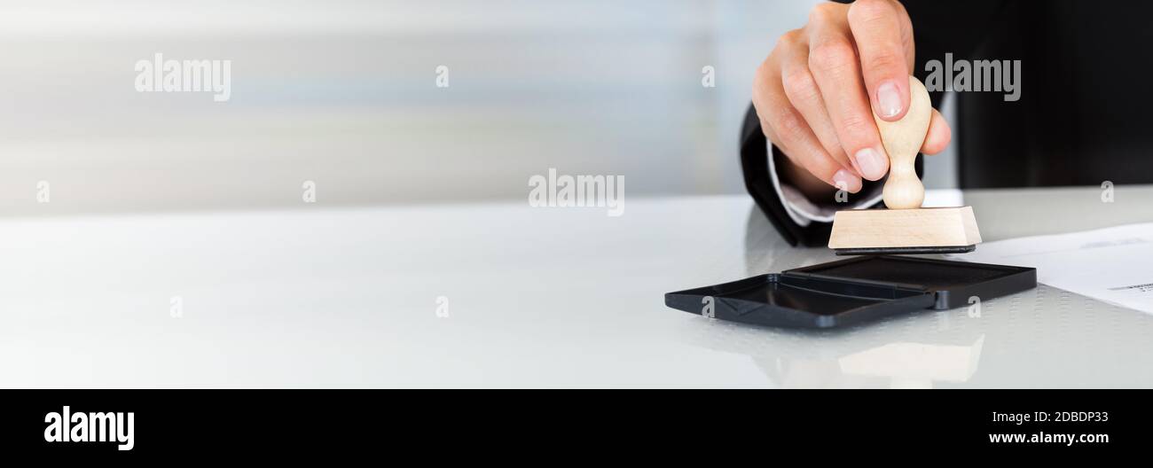 Hand Holding Rubber Stamp For Document Approval. Legal Paperwork Stock ...