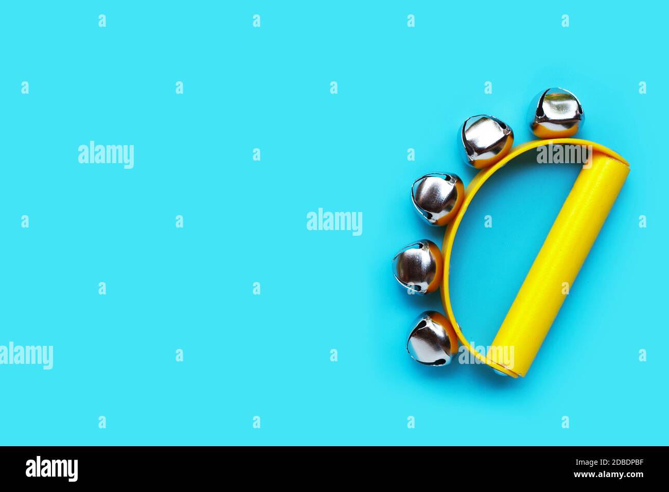 Hand bells musical instrument for ringing on blue background. Copy ...