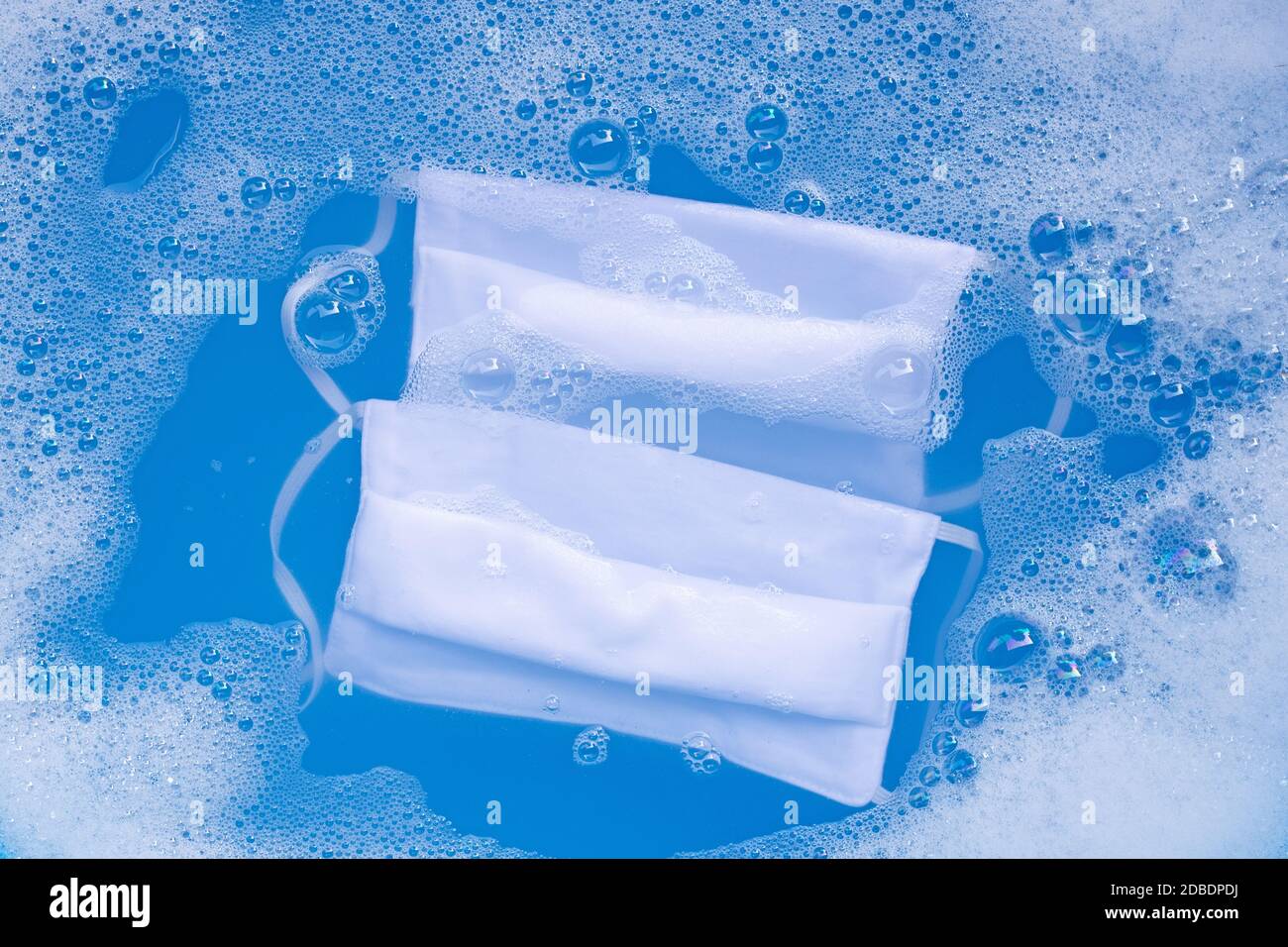 Cloth masks soak in powder detergent water dissolution before washing ...