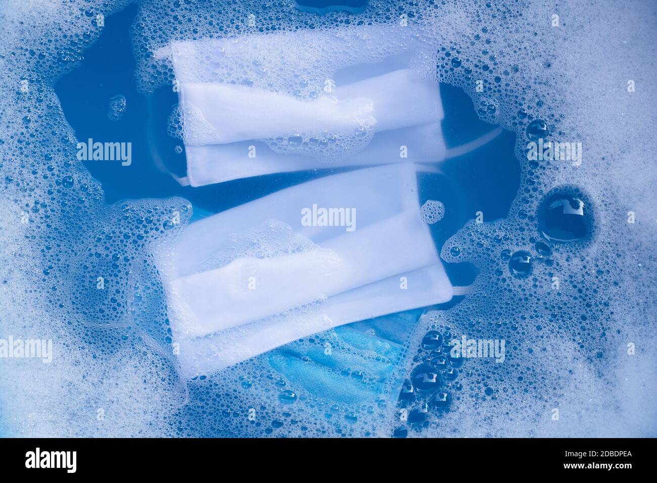 Cloth masks soak in powder detergent water dissolution before washing ...