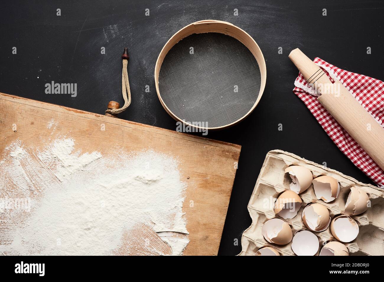 wooden round sieve, white wheat flour, tray of chicken eggs in a tray ...