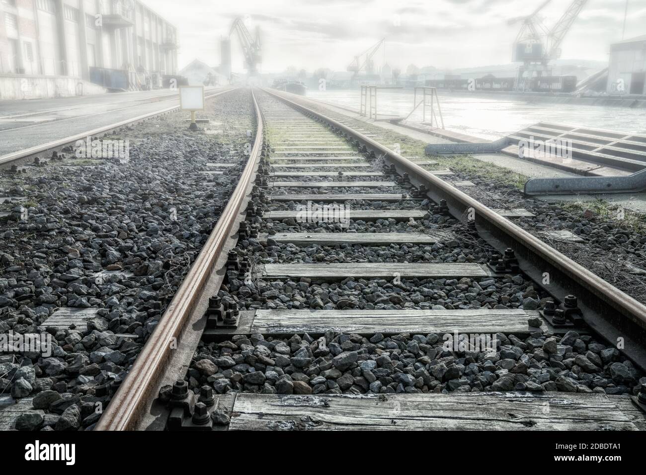 A port envelope with railroad tracks in the foreground Stock Photo - Alamy