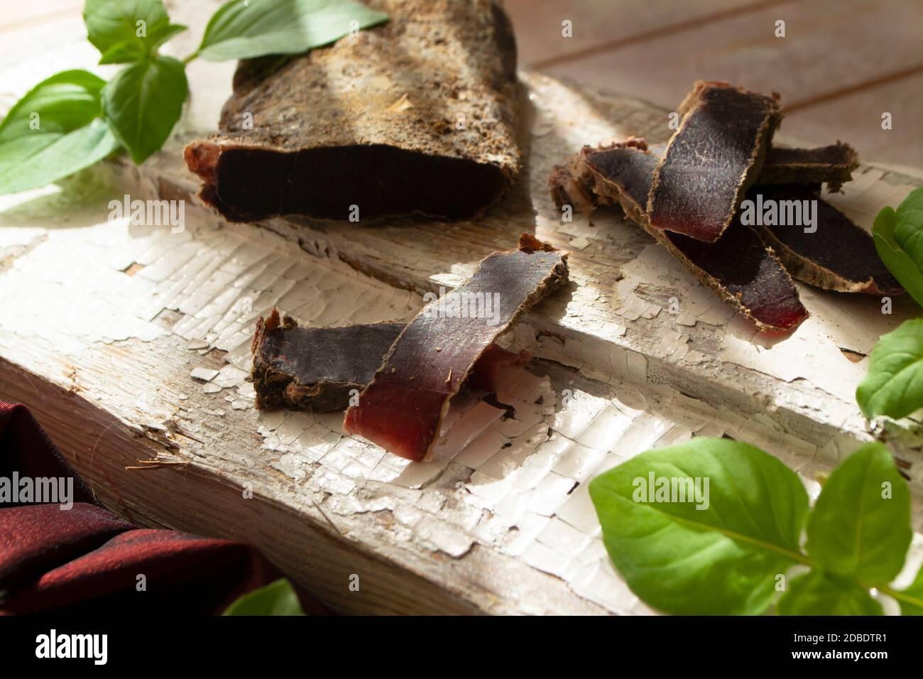 dried roe deer meat on a rustic cutting board Stock Photo - Alamy