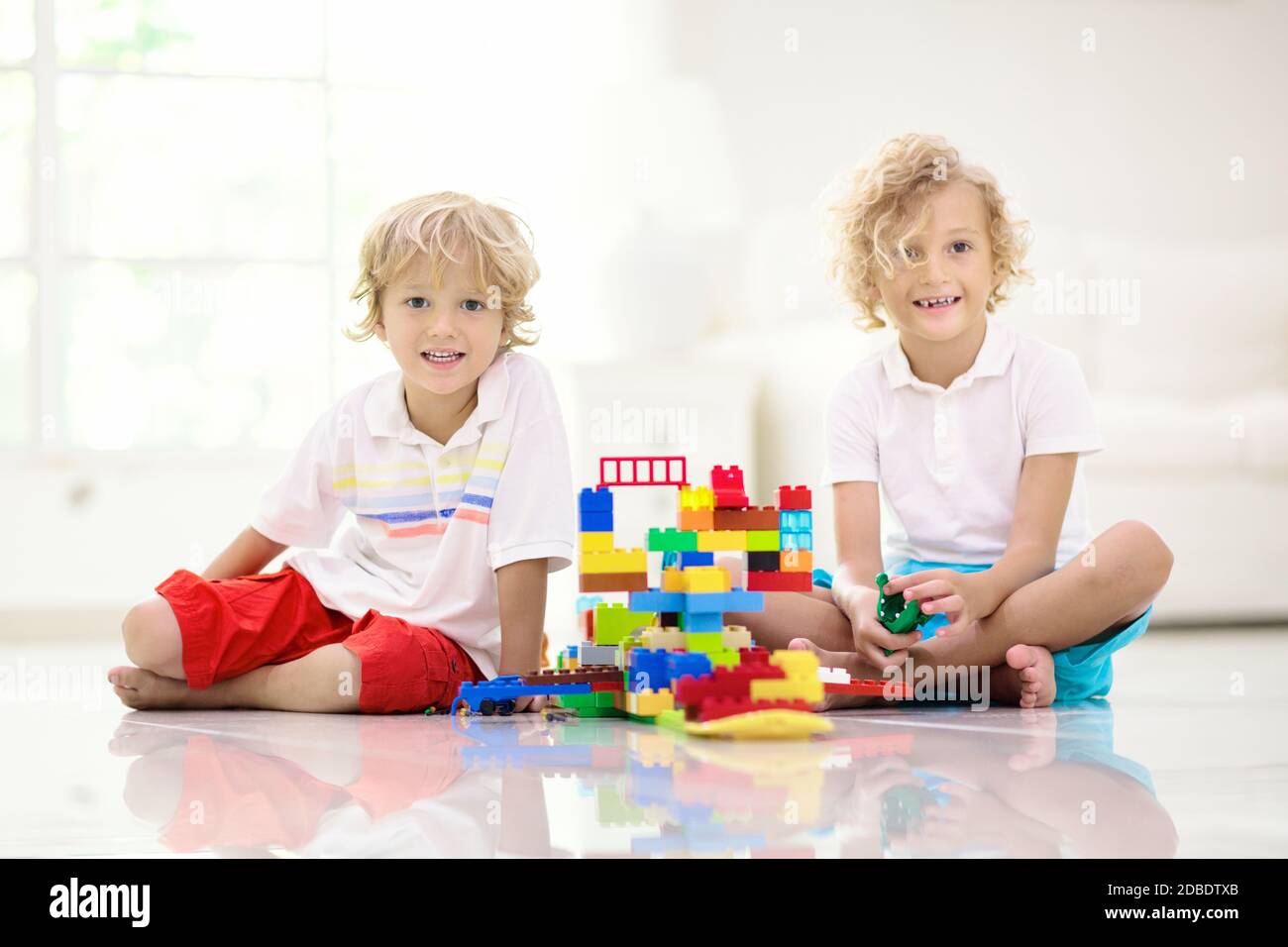 Child playing with colorful toy blocks. Kids play with plastic bricks ...
