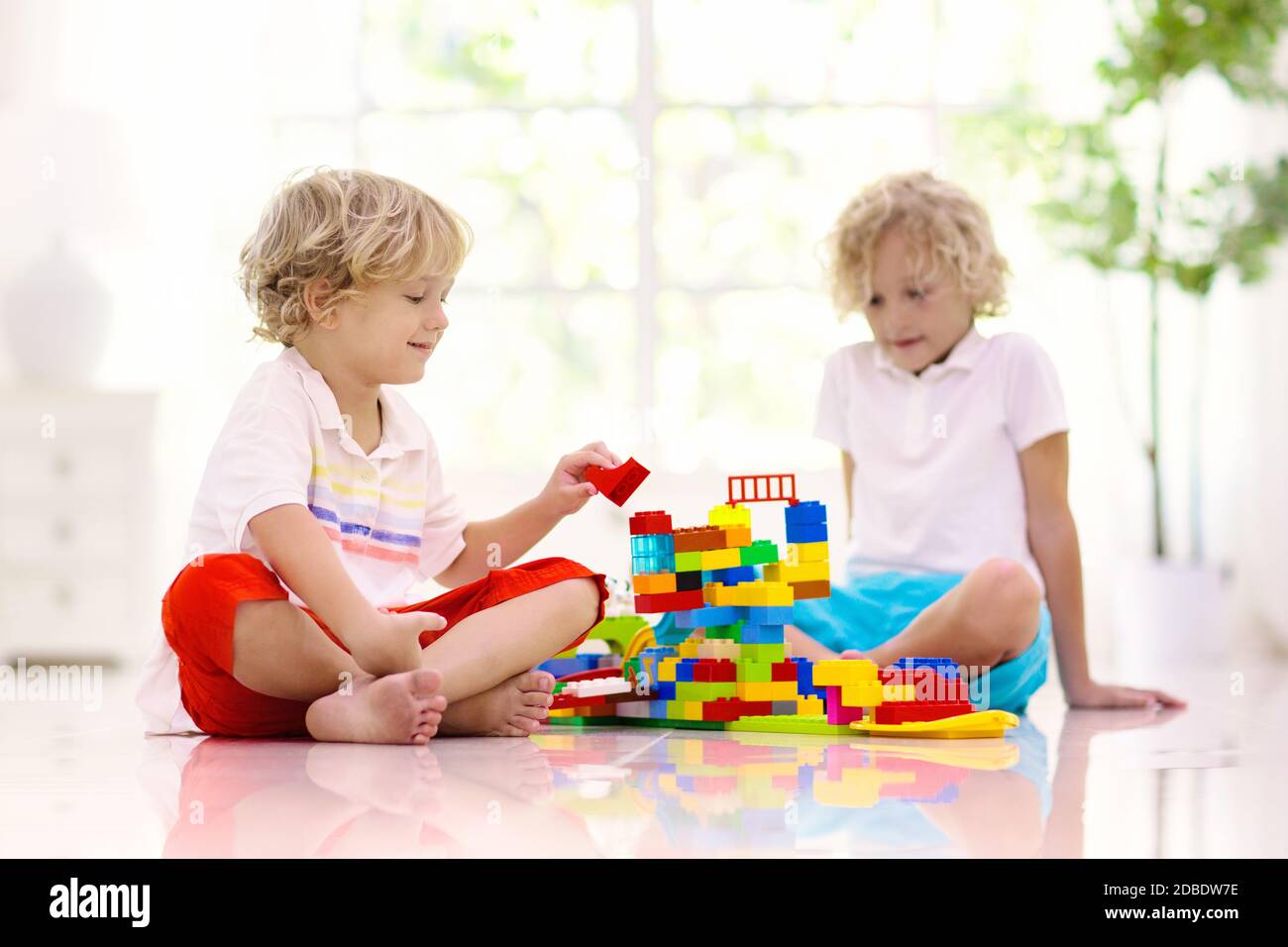 Child playing with colorful toy blocks. Kids play with plastic bricks ...