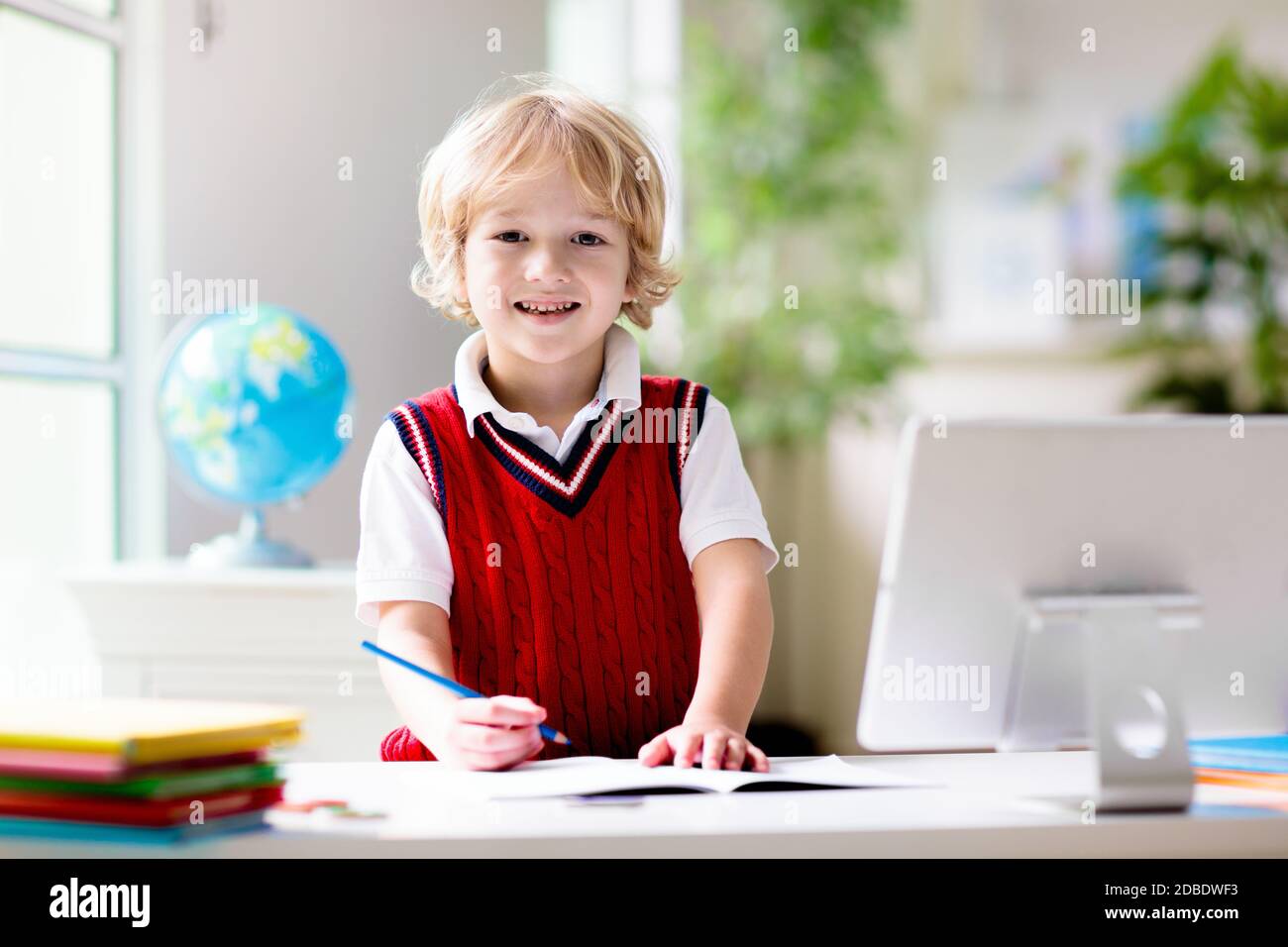 Online remote learning. School kids with computer having video ...