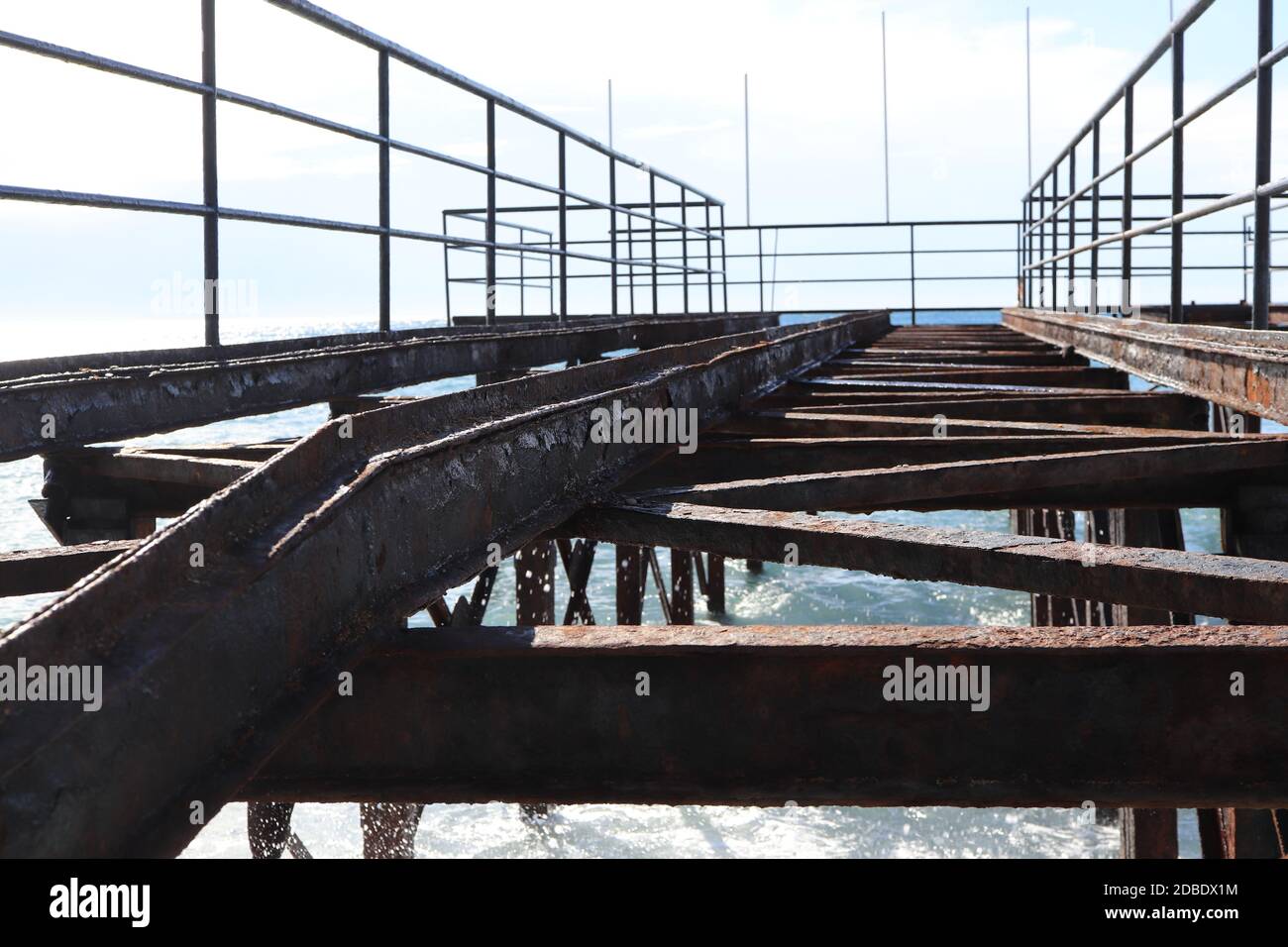 Hard rust pier construction on sea beach Stock Photo - Alamy
