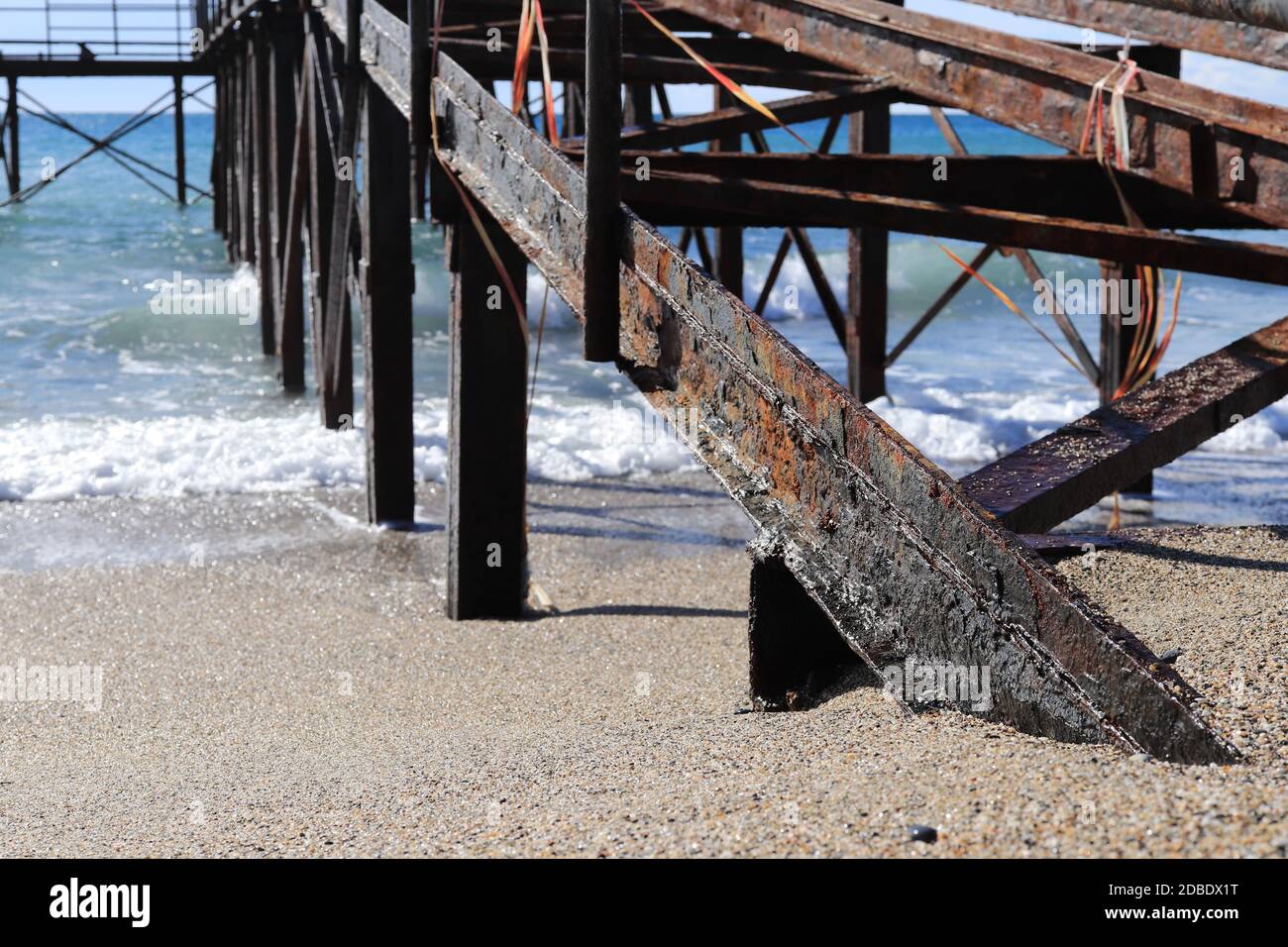 Hard rust pier construction on the beach Stock Photo - Alamy