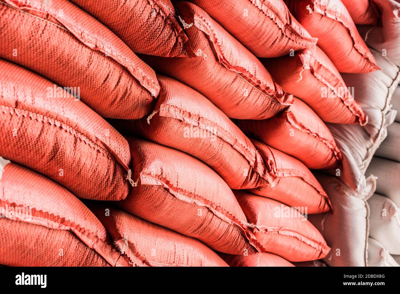 Piles of sacks with agricultural products in storehouse Stock Photo - Alamy