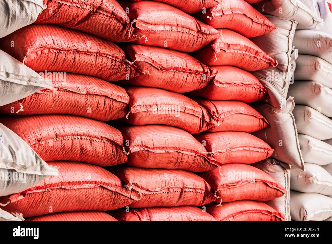 Piles of sacks with agricultural products in storehouse Stock Photo - Alamy