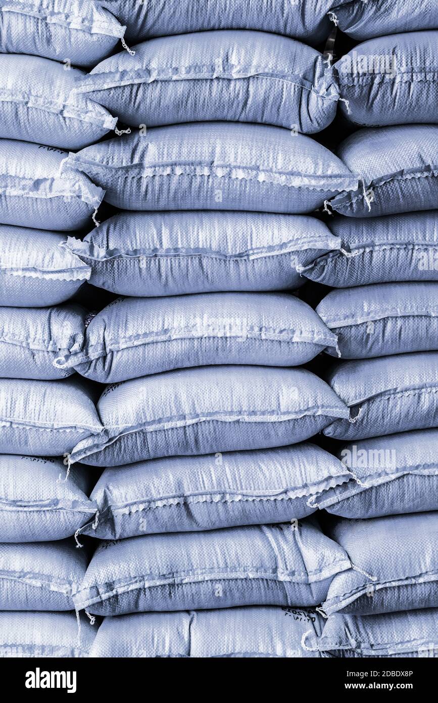 Piles of sacks with agricultural products in storehouse Stock Photo - Alamy