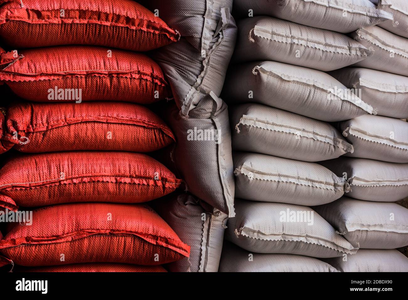 Piles of sacks with agricultural products in storehouse Stock Photo - Alamy