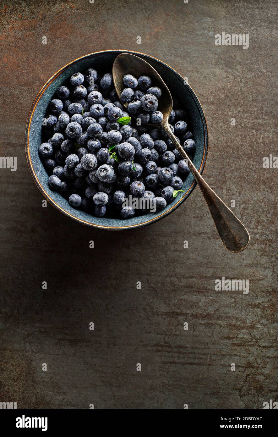 Freshly picked blueberries in bowl with spoon. Concept for healthy ...