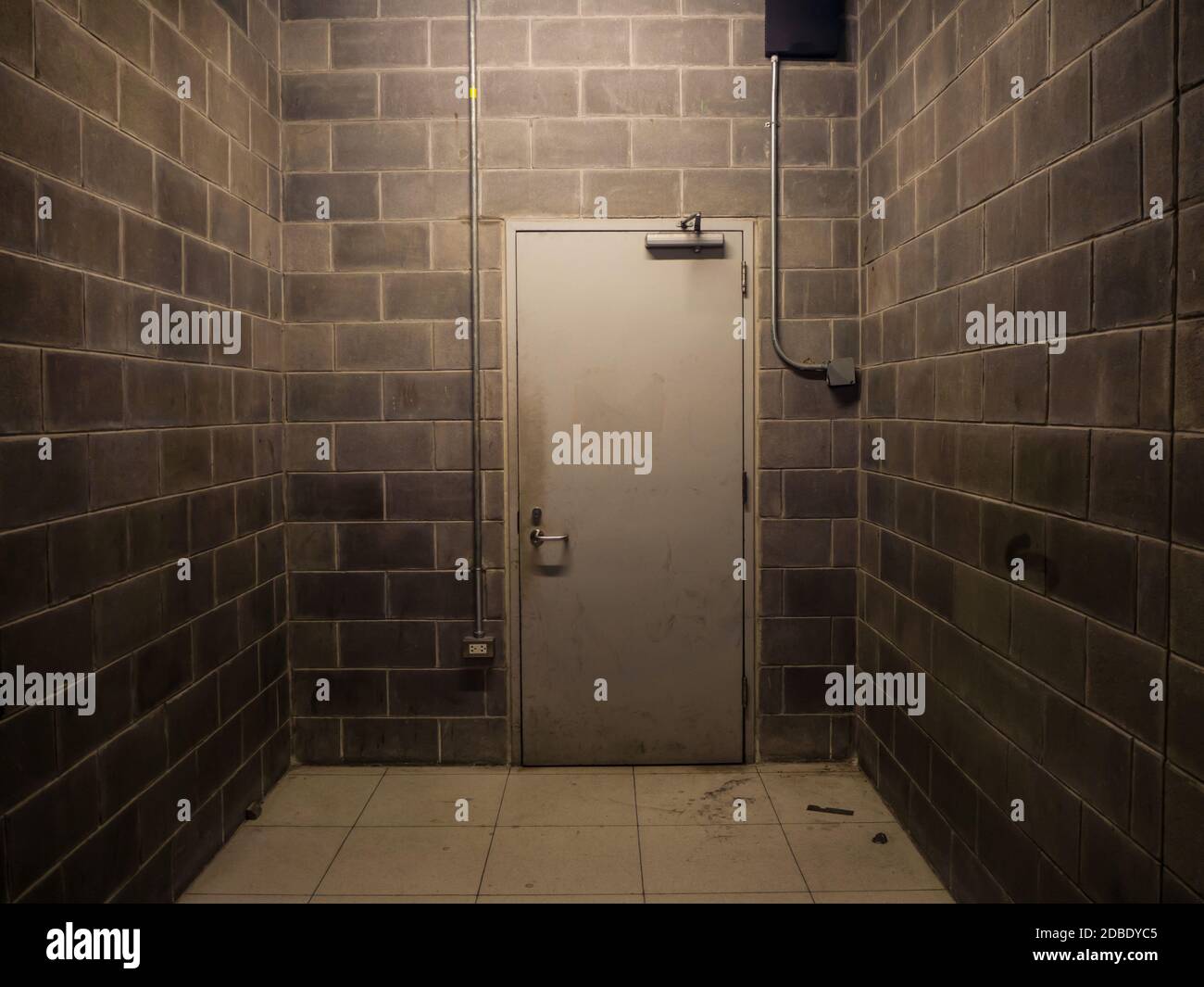 The metal Beige back door of building with old brick wall Stock Photo ...