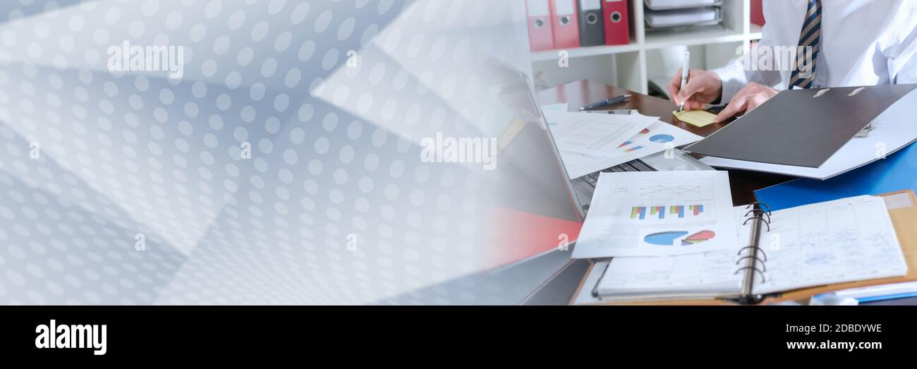 Businessman working at an untidy and cluttered desk; panoramic banner ...