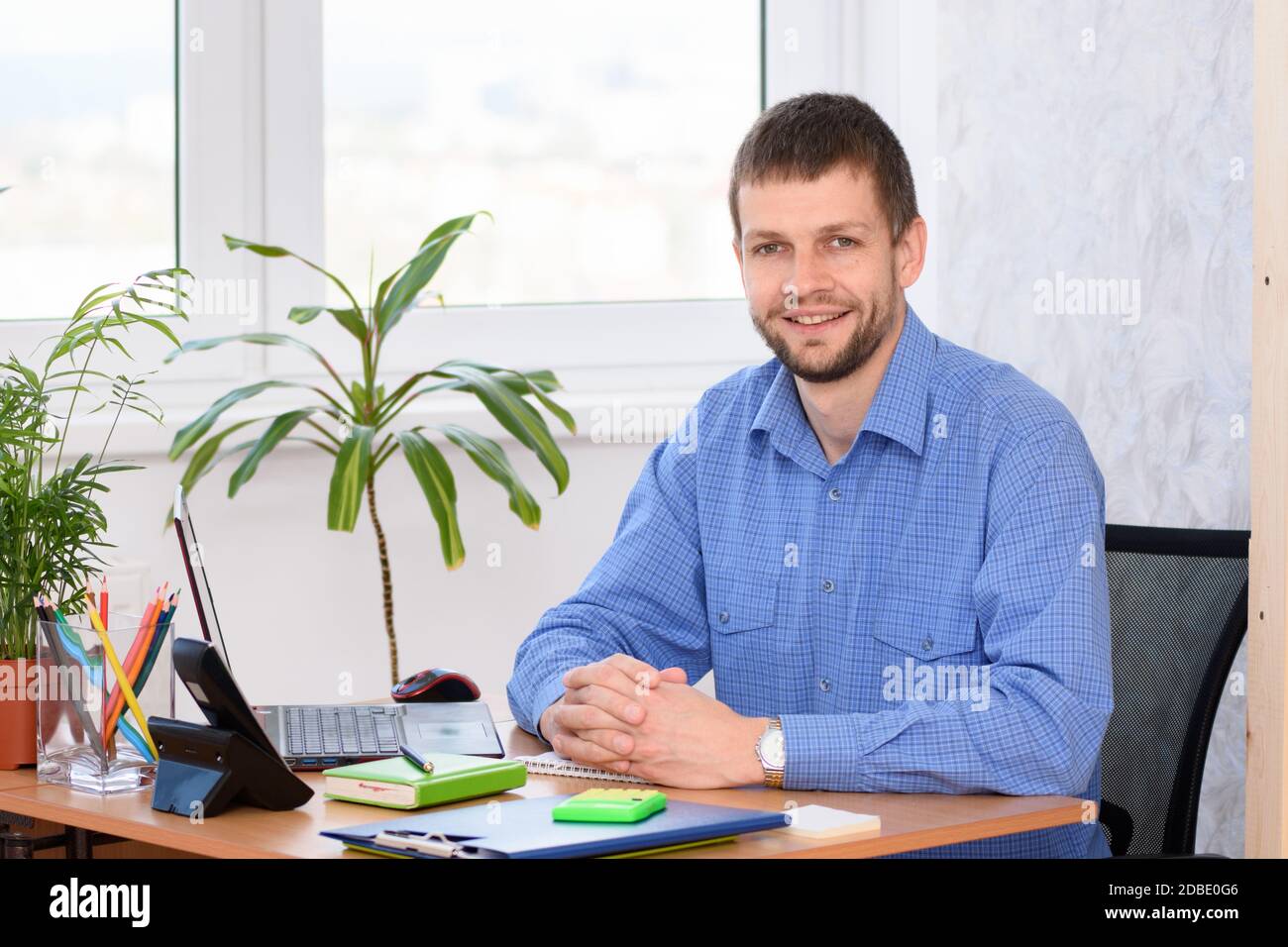 Successful business man in the office at the workplace Stock Photo - Alamy