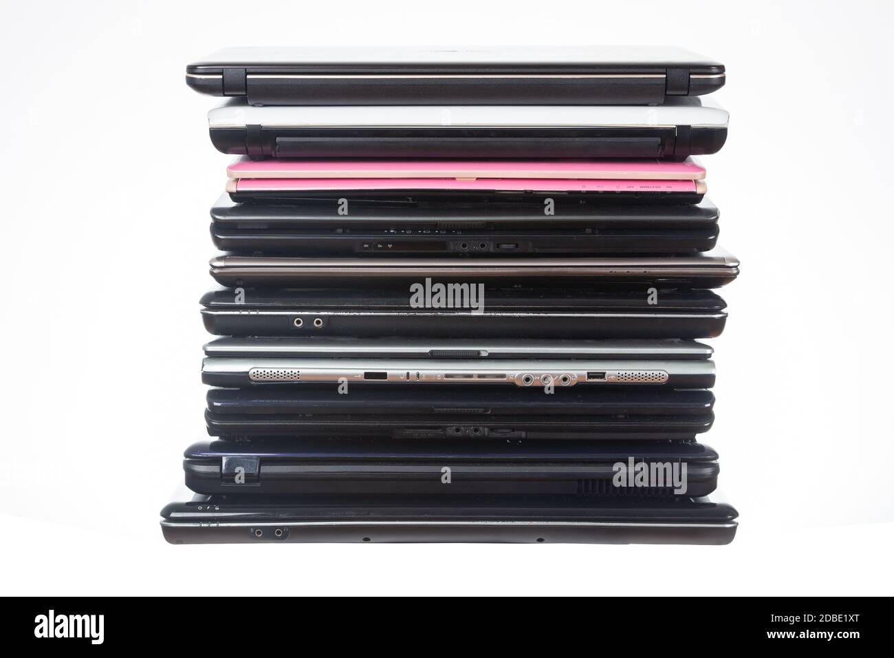 Stack of used laptops in different colors and models. Tha notebooks for ...