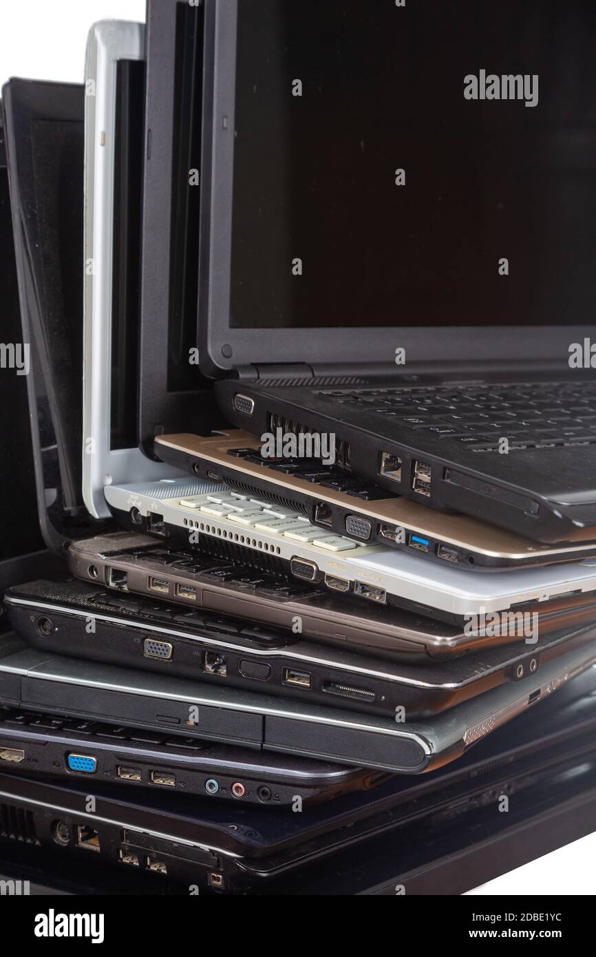 Stack of used laptops in different colors and models. Tha notebooks for ...