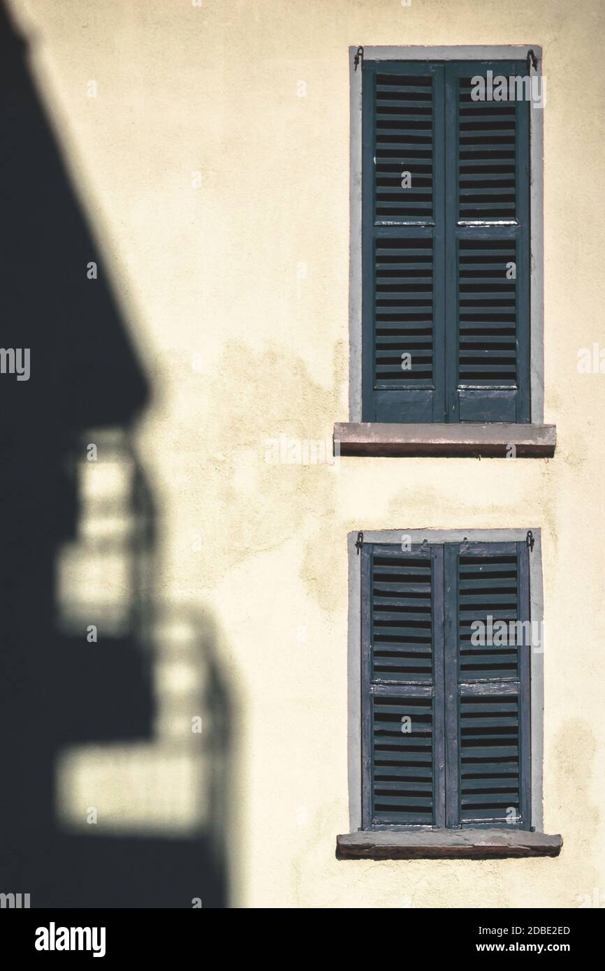 Two closed windows and the shadow of the building opposite Stock Photo ...