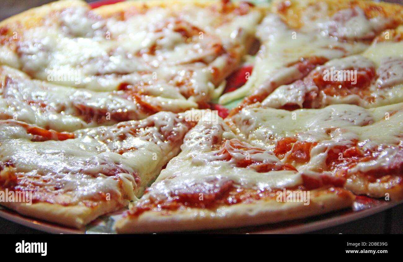 Slices of fresh appetizing pizza with delicious ingredients close up ...