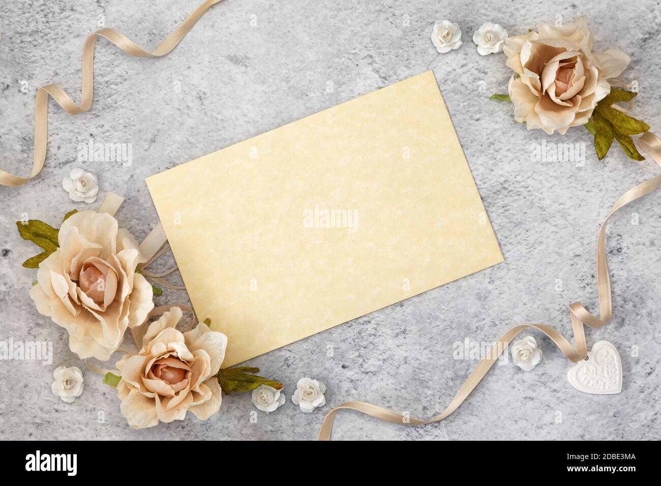 Wedding invitation cards papers laying on table decorated with roses ...