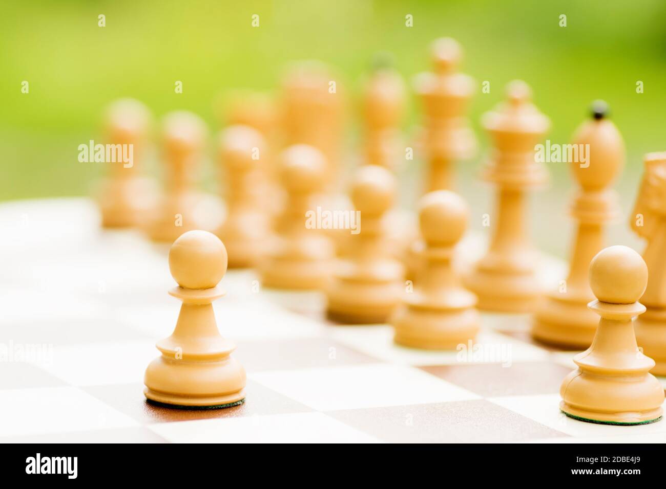 Pawn chess piece and other white chess pieces are on chess board on ...