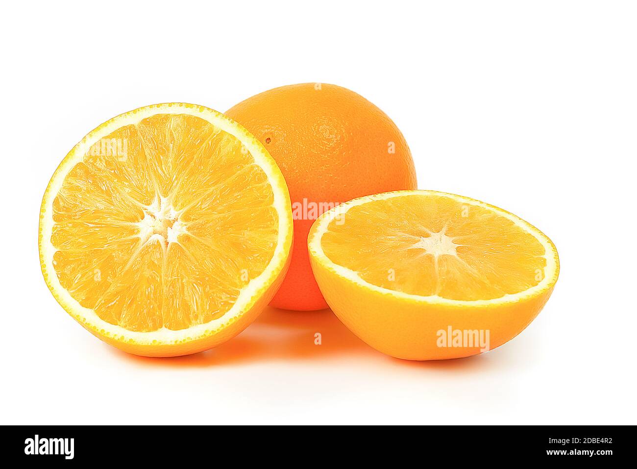 Orange whole one bright and two juicy halves in the foreground isolated ...