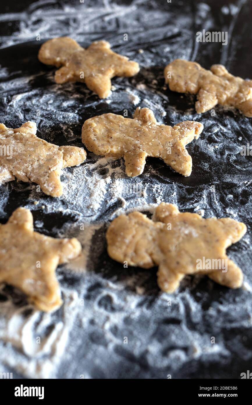 Person baking Gingerbread man cookies, Person hands in dough with ...