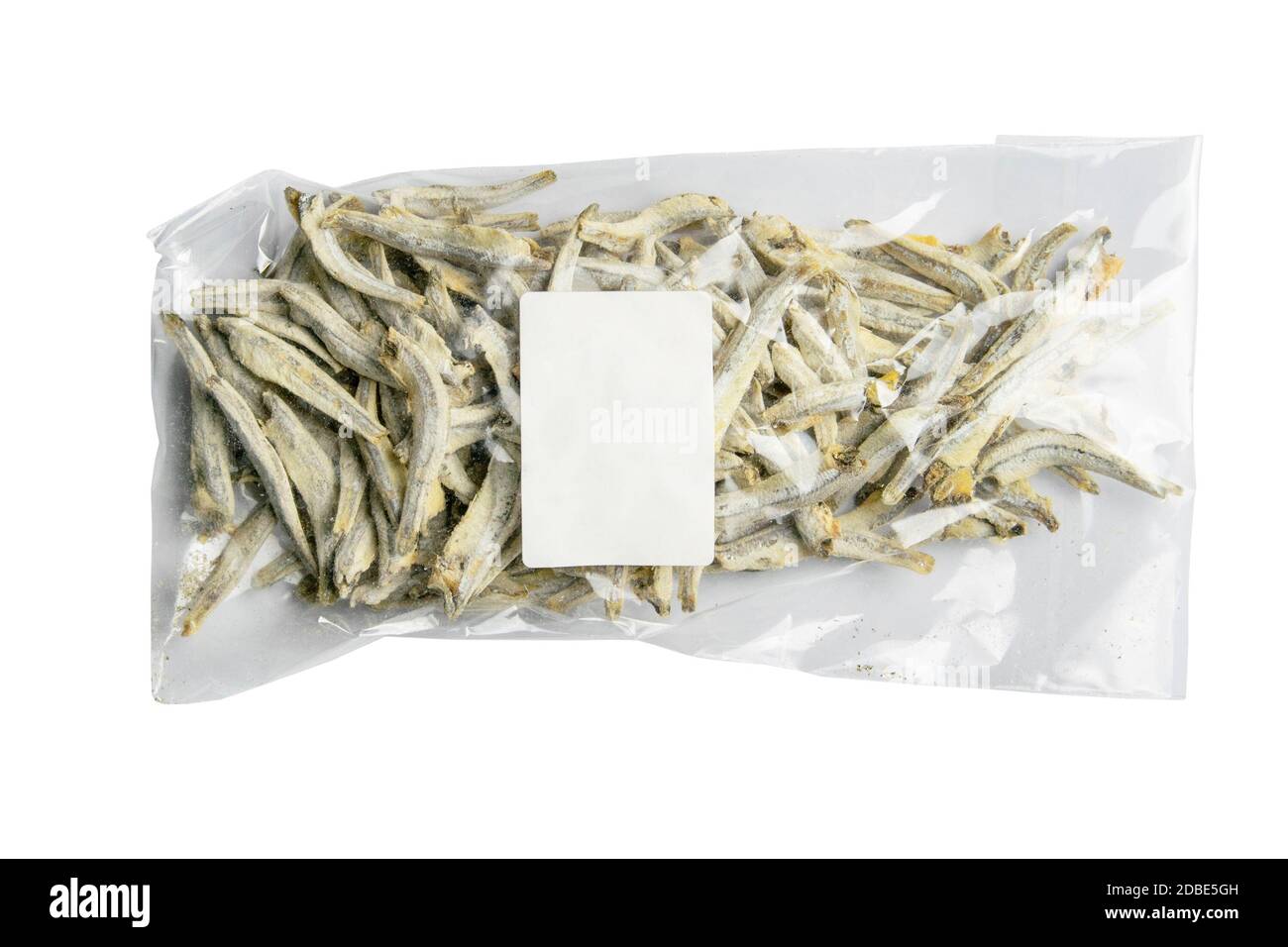 Dried salted anchovies in a transparent package with a white label ...