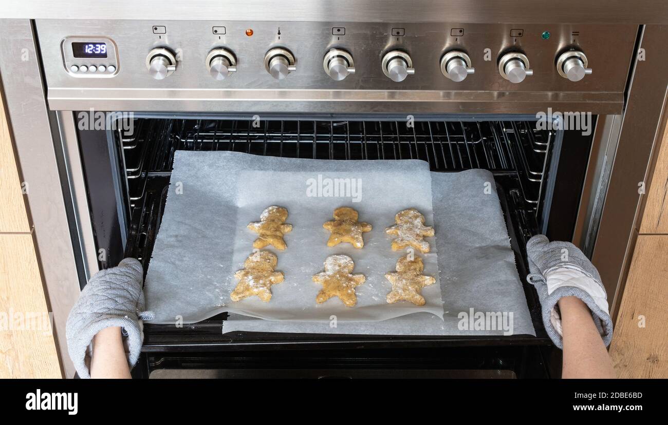 Baking Gingerbread man in the oven, Woman making homemade gingerbread ...