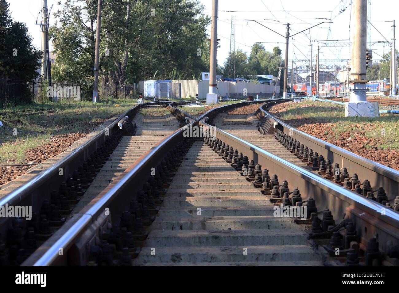 Railroad Crossing. Railway tracks with train station landscape Stock ...