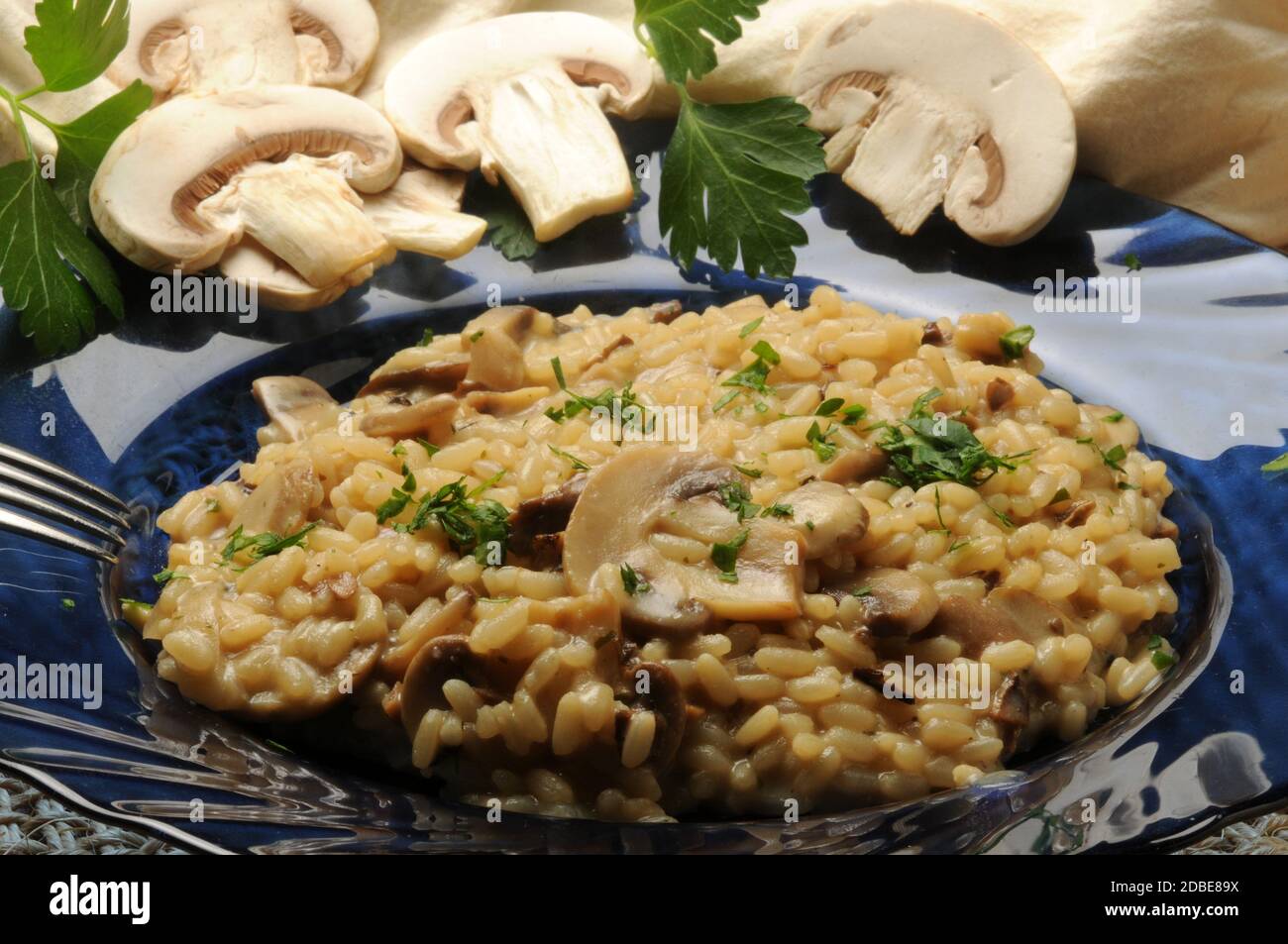 Plate of risotto with mushrooms and parsley Stock Photo - Alamy