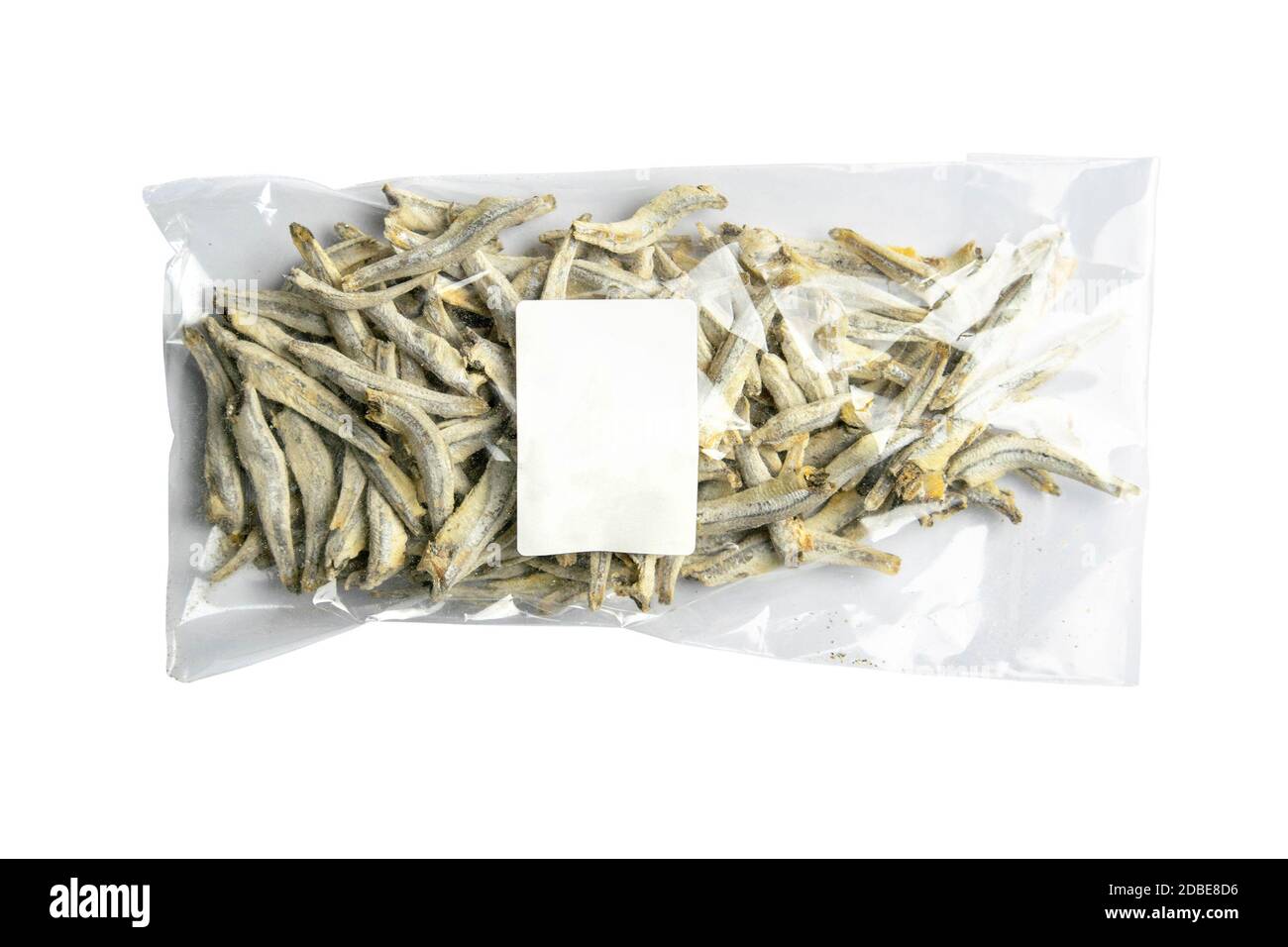Dried salted anchovies in a transparent package with a white label ...