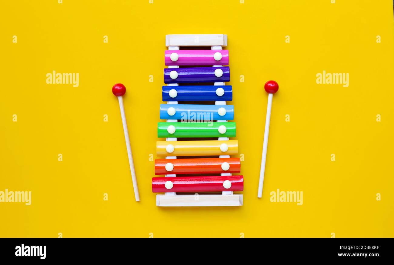 Colorful xylophone on yellow background. Copy space Stock Photo - Alamy