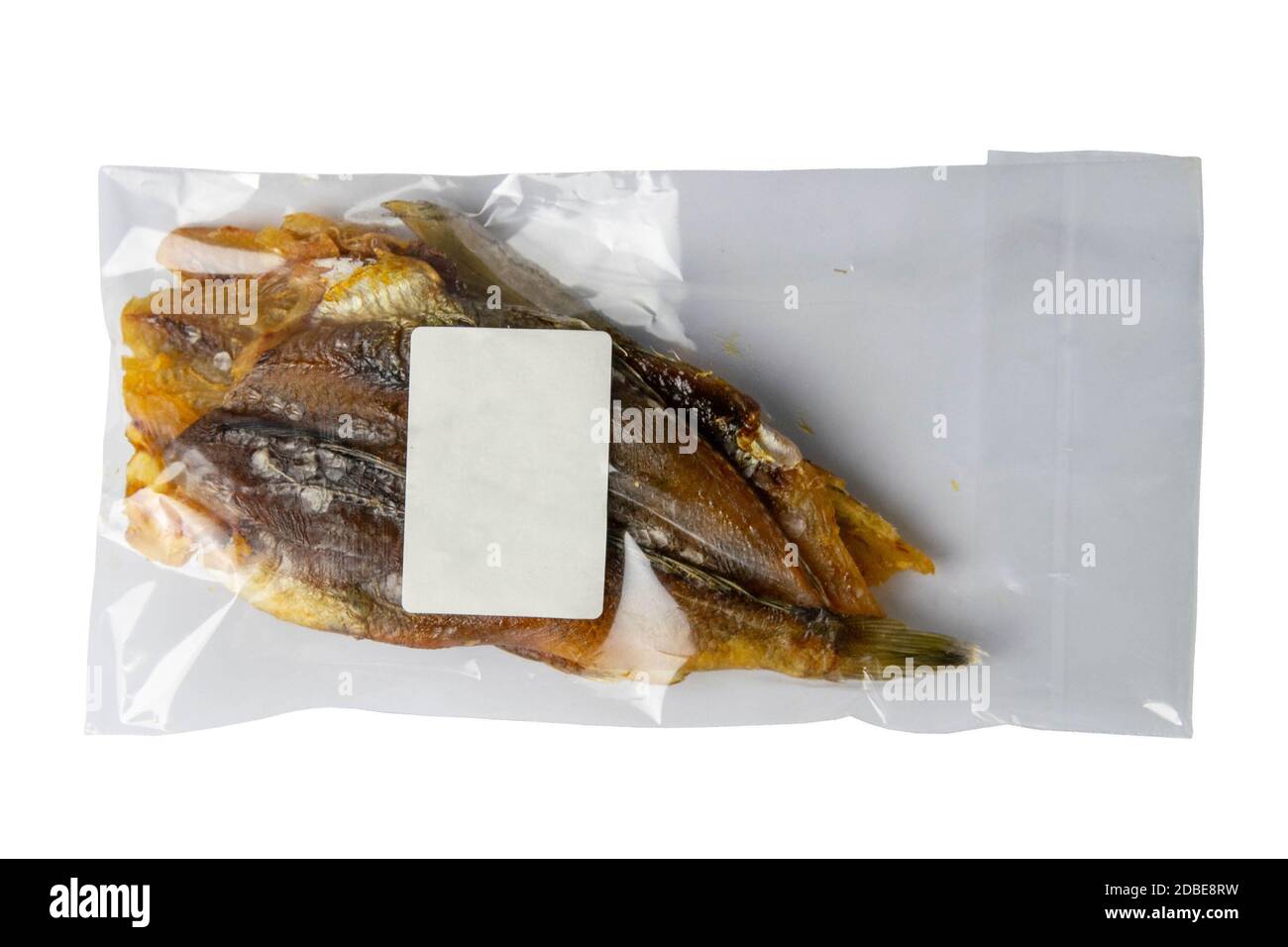 Dried blue whiting fish in a transparent package whith white label ...