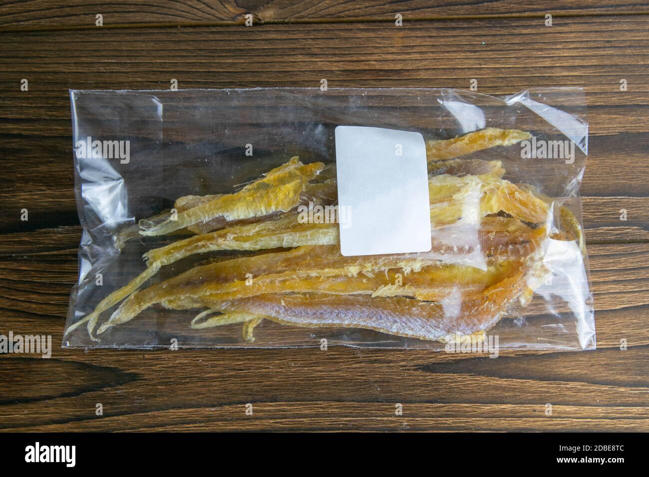 Dried tuna fillet in a transparent package with white label appetizer ...