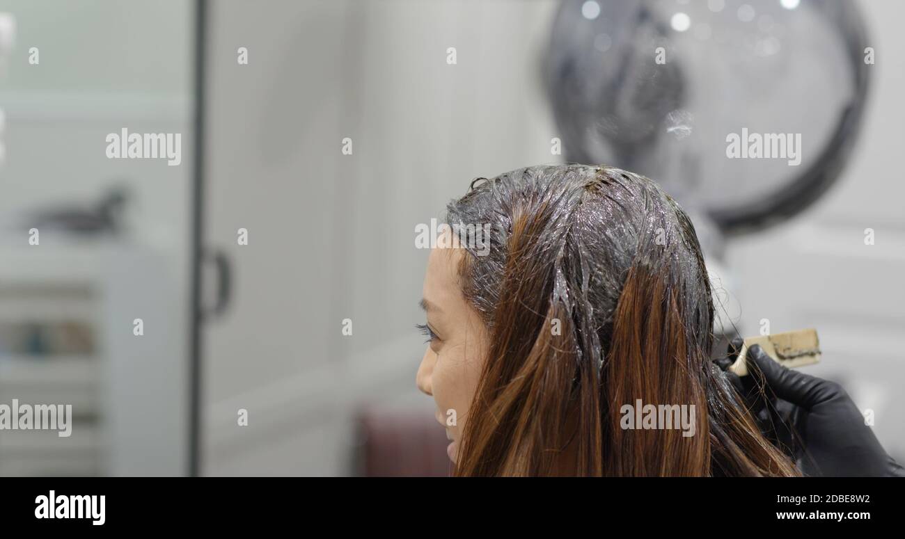 Woman with hair color dye in beauty salon Stock Photo - Alamy