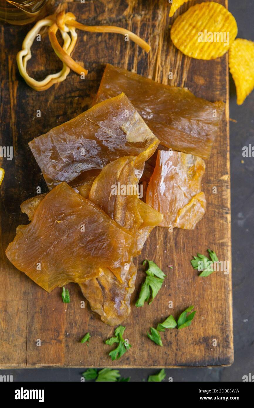 Dried catfish fillet on wooden background. Snack on fish with beer ...