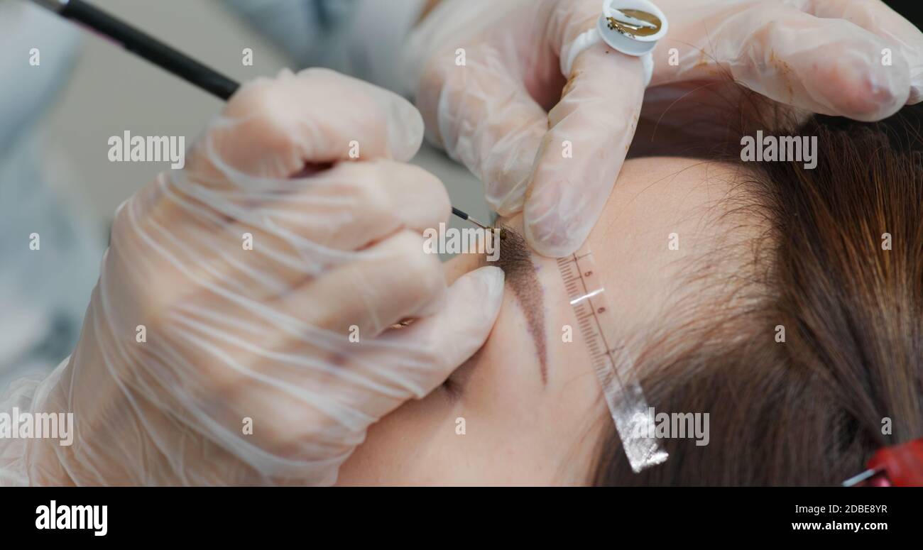 Process woman applying permanent tattoo hi-res stock photography and ...