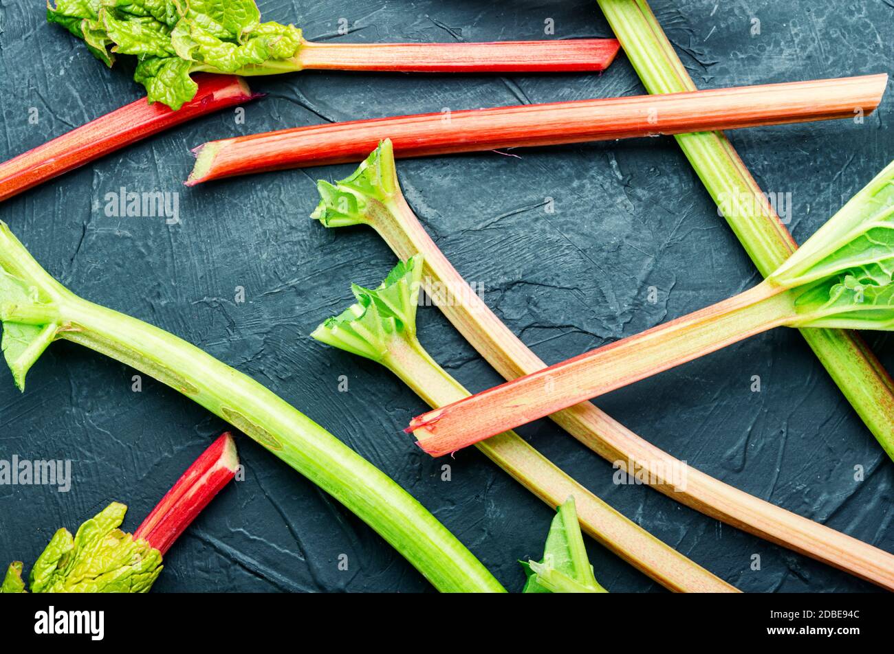Fresh red rhubarb stalks with green leaves.Fresh rhubarb stem Stock ...