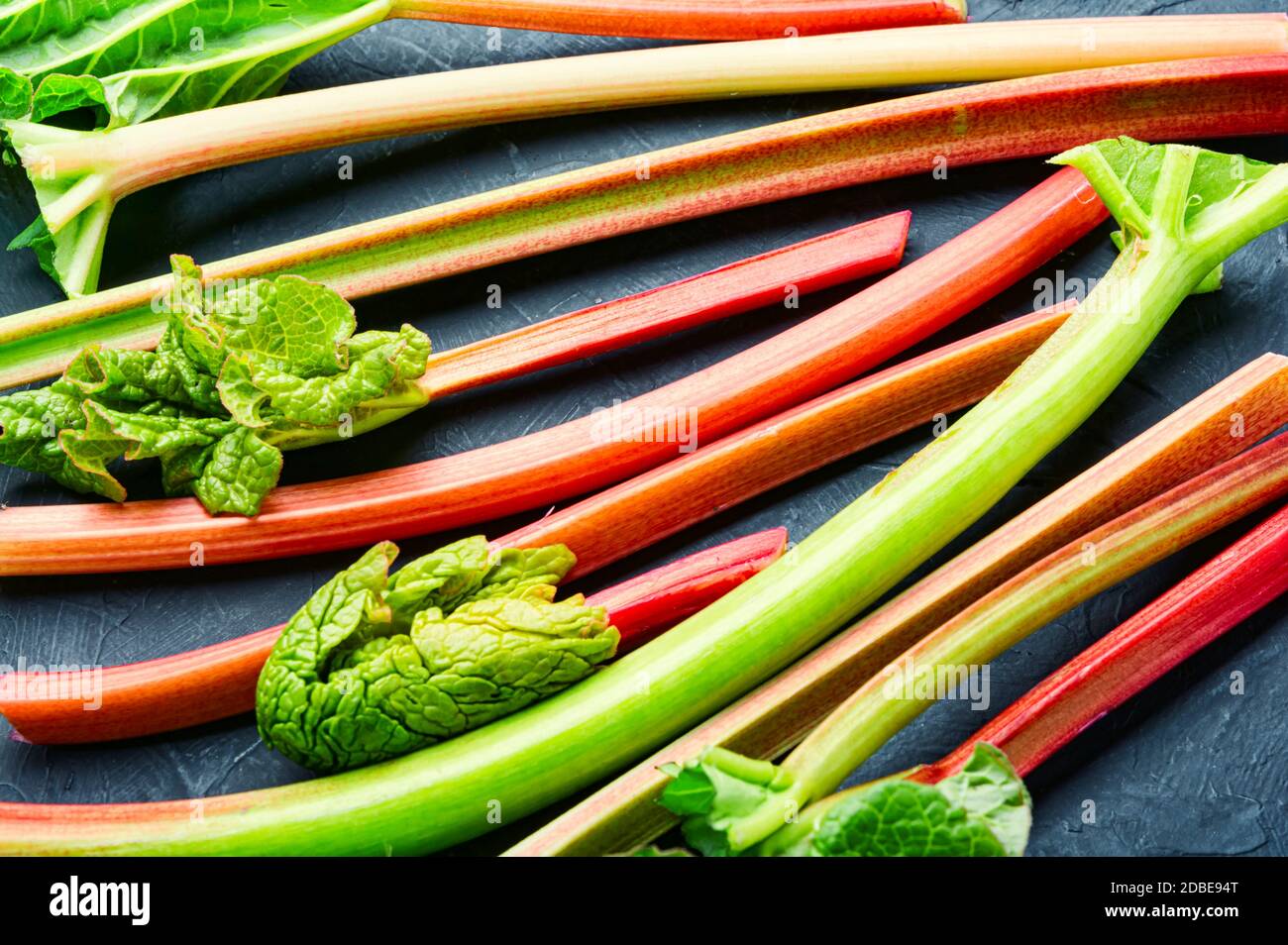 Fresh red rhubarb stalks with green leaves.Fresh rhubarb stem Stock ...